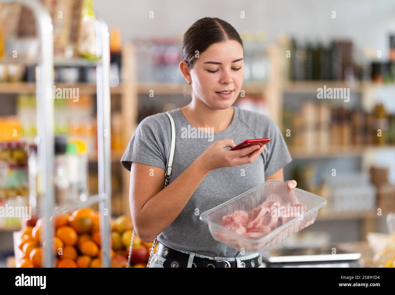 Woman scanning qr code of meat packaging Stock Photo - Alamy