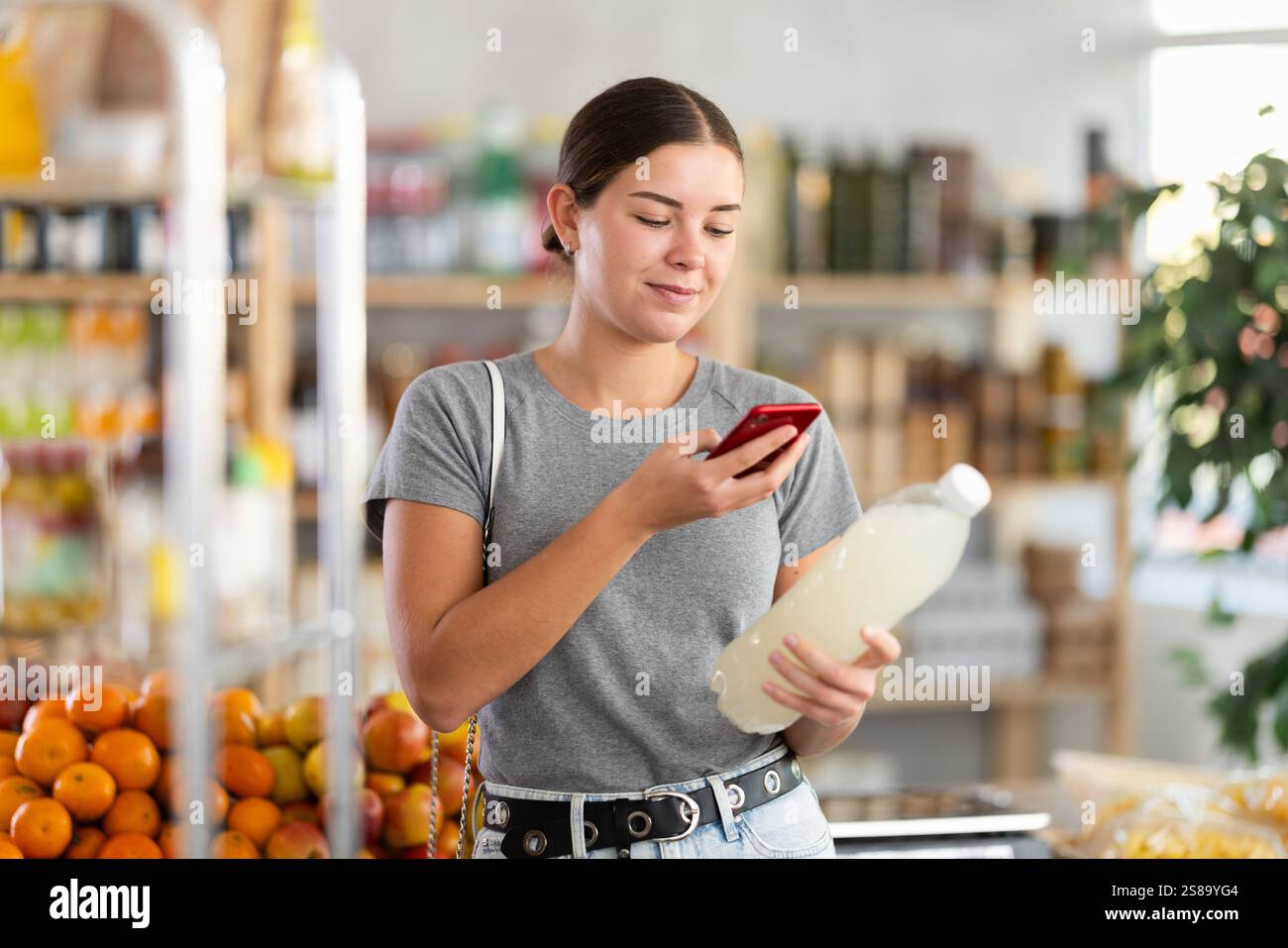 In shop youth girl scan QR code and take reading drink package bottle ...