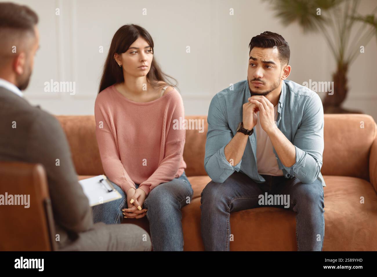 Couple talking at therapy session with professional man therapist Stock ...