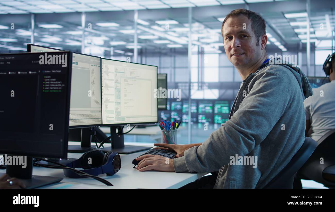 Portrait of smiling engineer inspecting server rows in data center. Happy man supervising ...