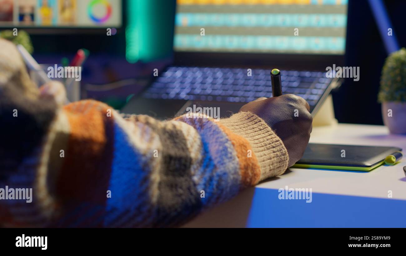 Male graphic artist using essential digital tools on dual monitors ...