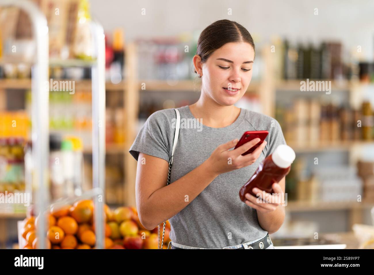 Young woman scanning qr code for ketchup Stock Photo - Alamy