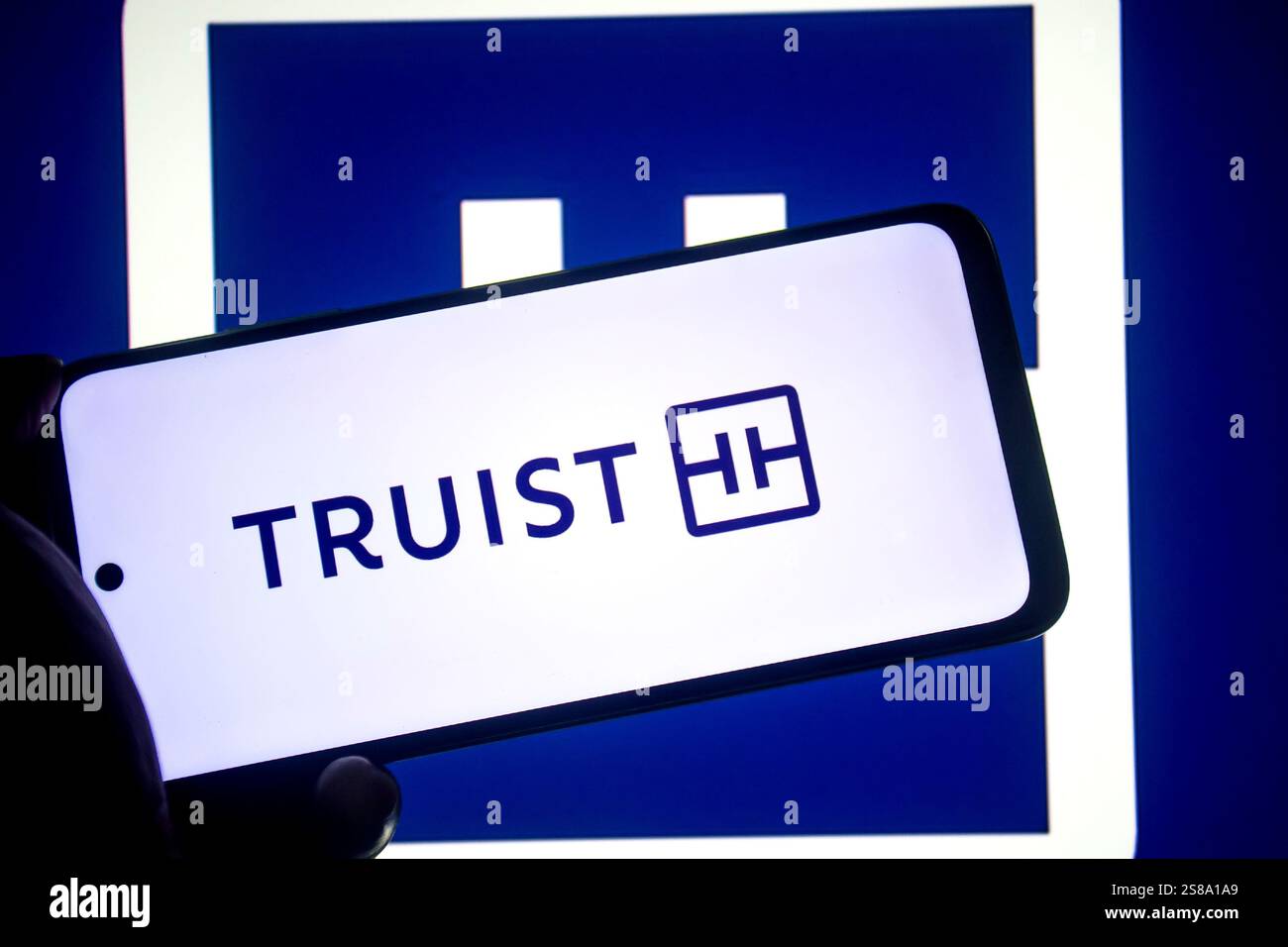 In this photo illustration, a Truist logo is seen displayed on a ...