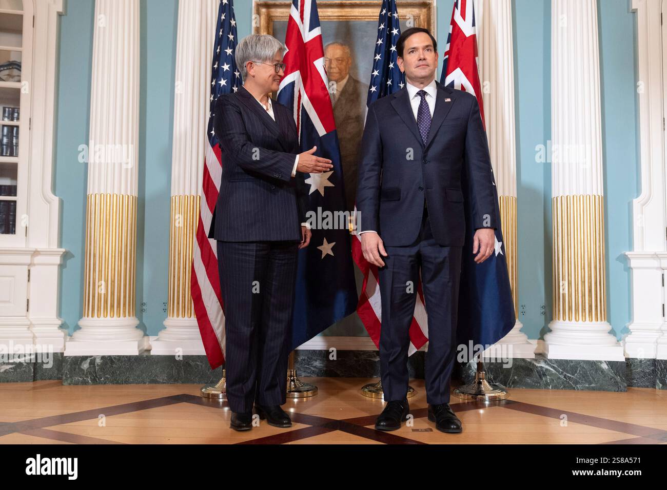 Australia's Foreign Minister Penny Wong, left, waits to shake hands ...