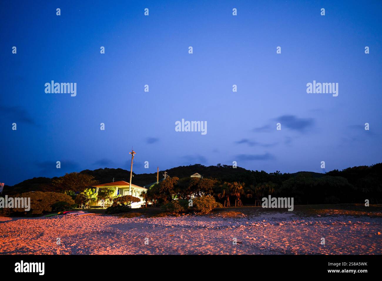 Night sky and seaside townscape before dawn in spring at Aka Island ...