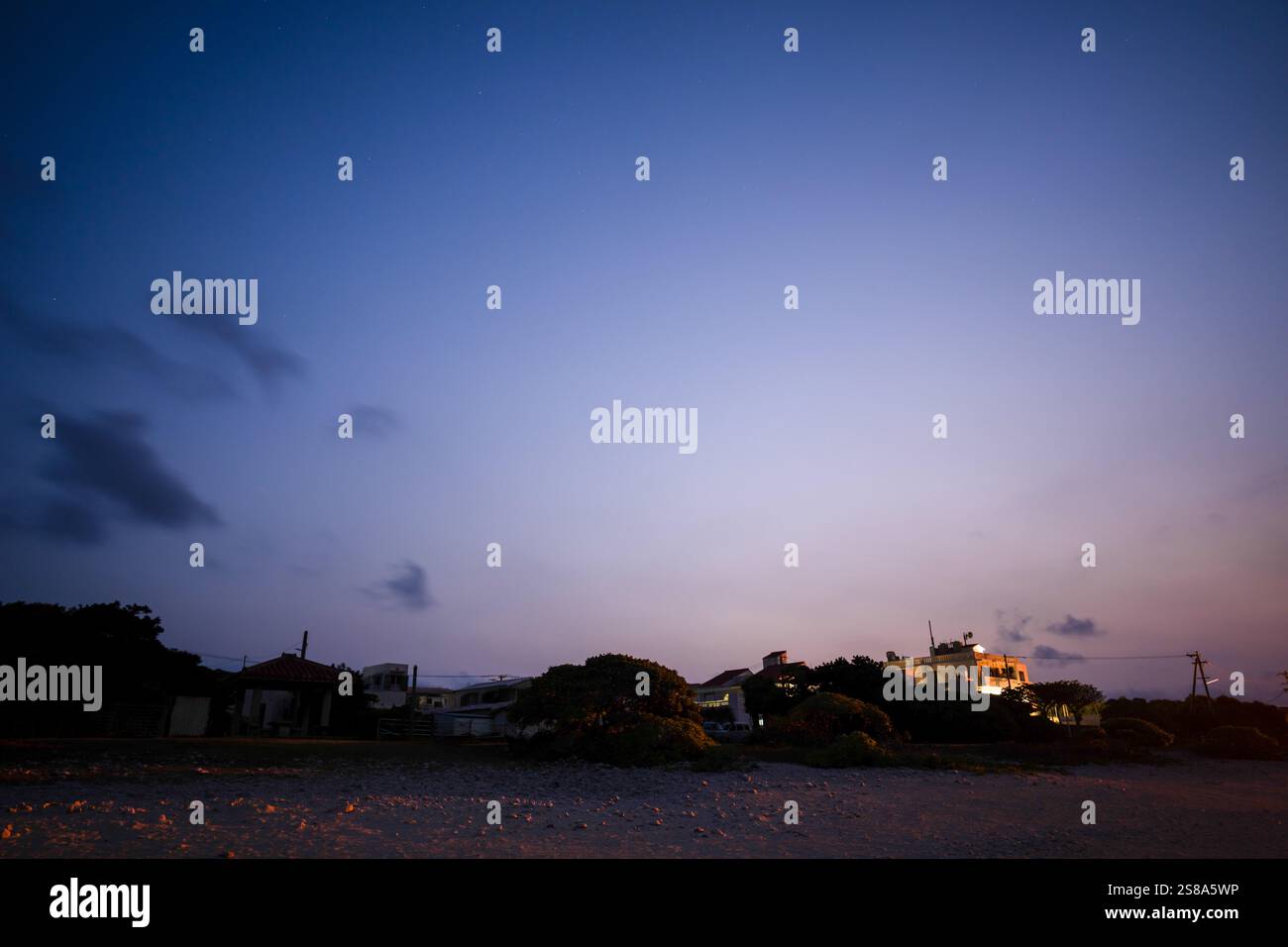 Night sky and seaside townscape before dawn in spring at Aka Island ...