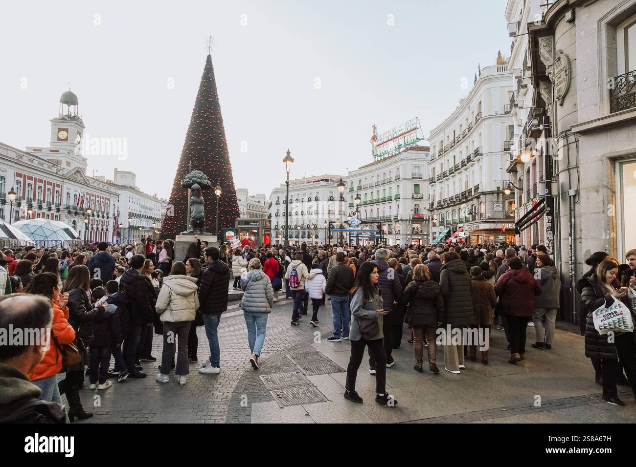 Puerta del Sol in Madrid, Spain, is filled with people and visitors ...