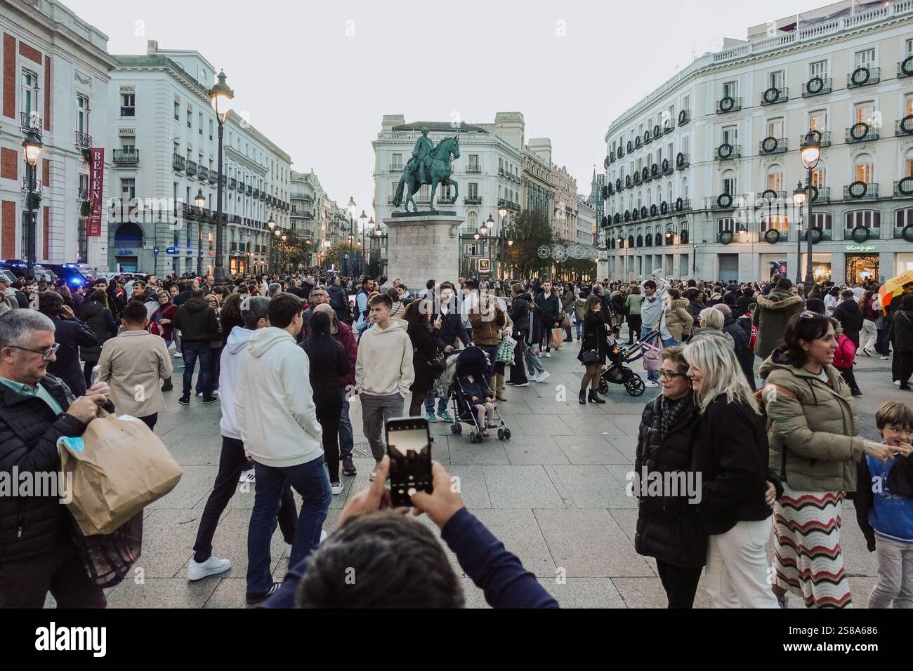 Puerta del Sol in Madrid, Spain, is filled with people and visitors ...
