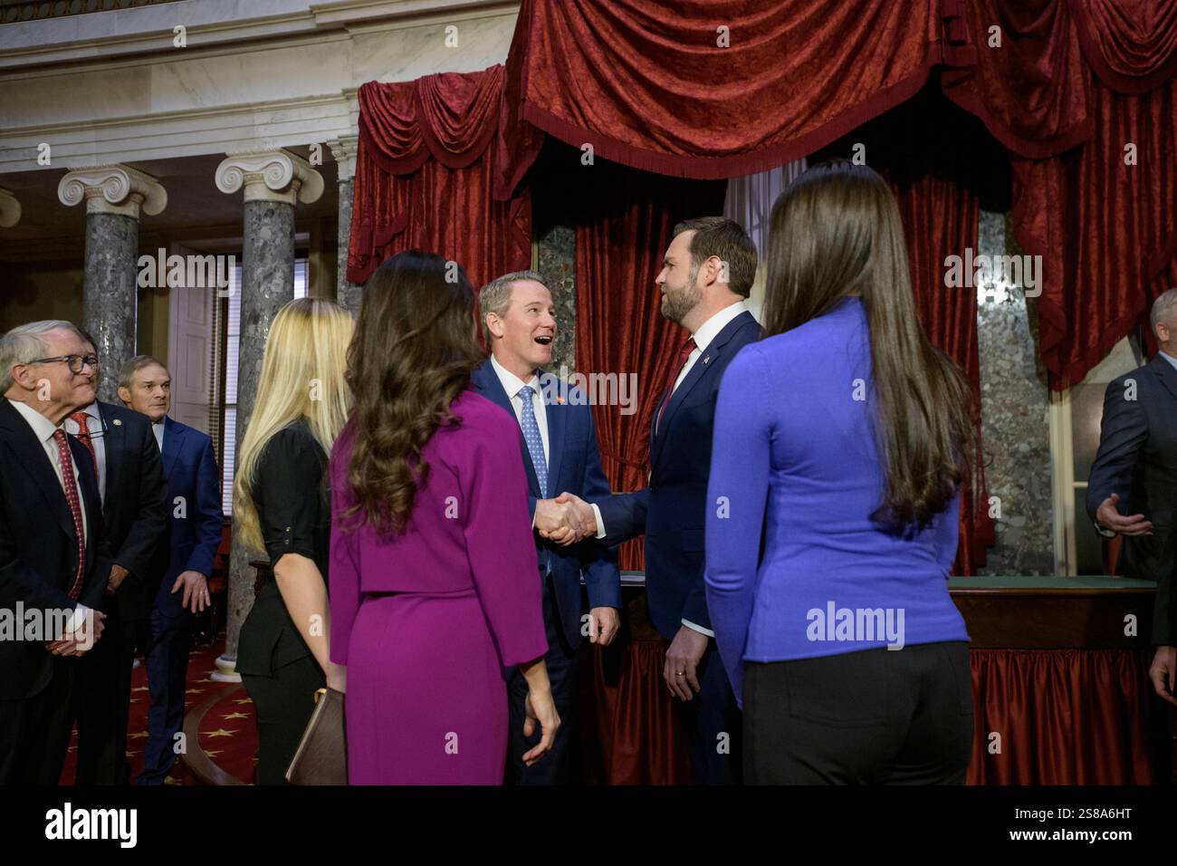 Vice President JD Vance, right, shakes hands with Sen. Jon Husted, R ...