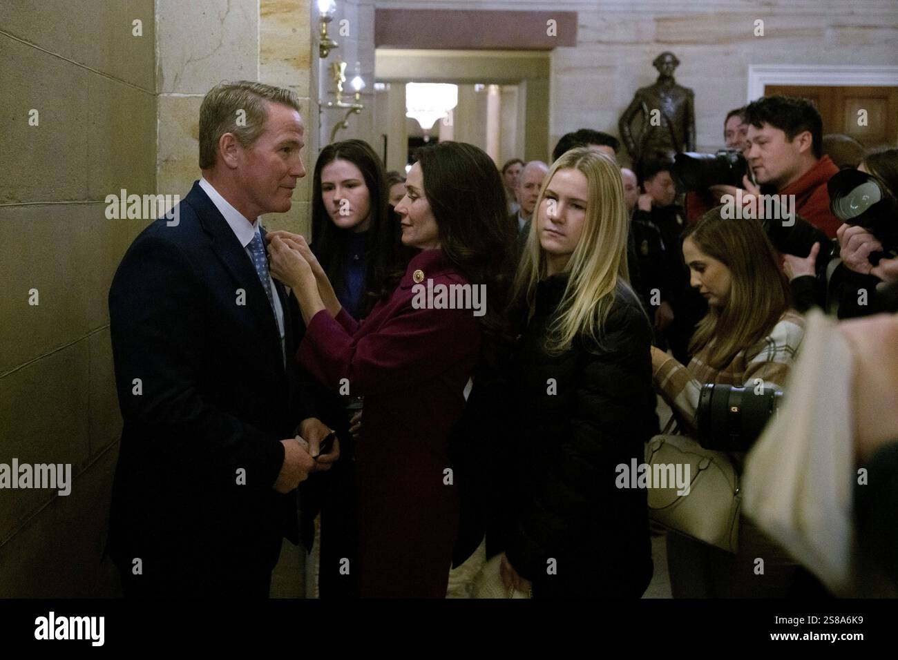 Tina Husted puts the Senate pin on the jacket of her husband, Sen. Jon ...