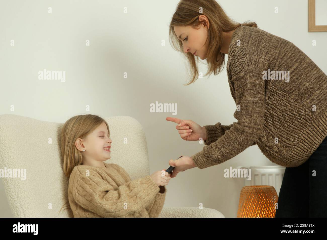Angry mother shouting and arguing with her little daughter over over ...