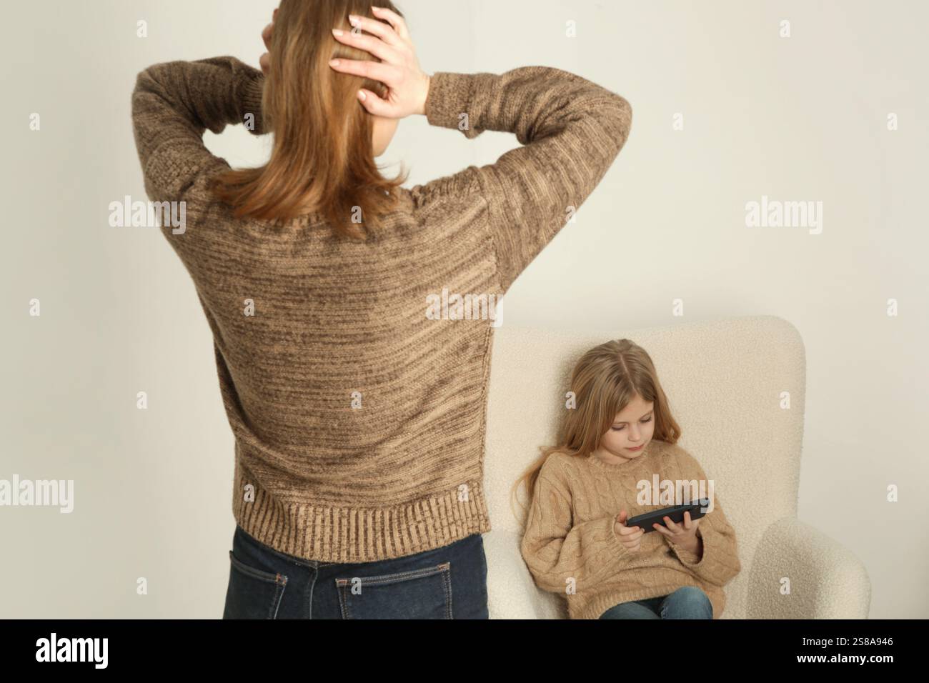 Angry mother shouting and arguing with her little daughter over over ...