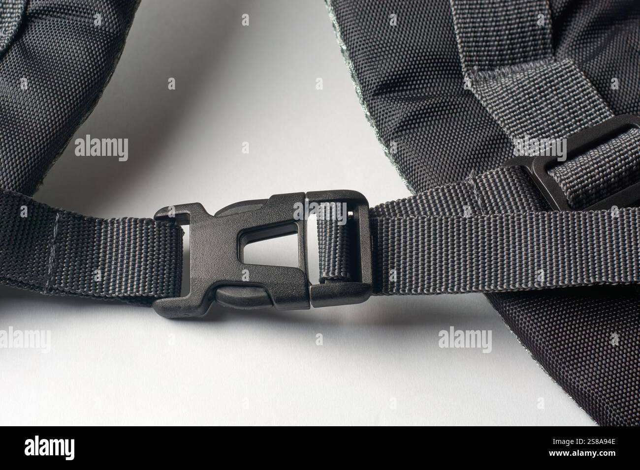 close-up of attached quick release black plastic buckle on shoulder ...