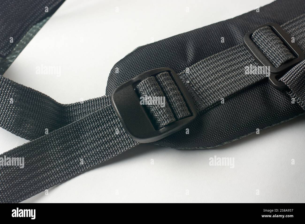 close-up of shoulder strap of black backpack, made of woven fabric with ...