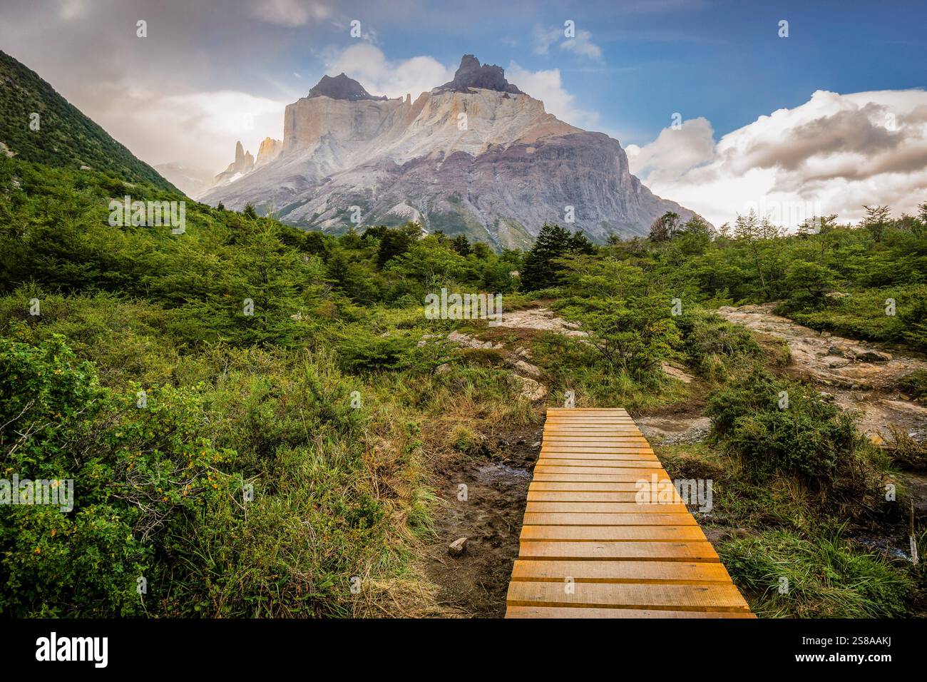 hiker crossing a wooden bridge, Valle del Frances, Torres del Paine ...