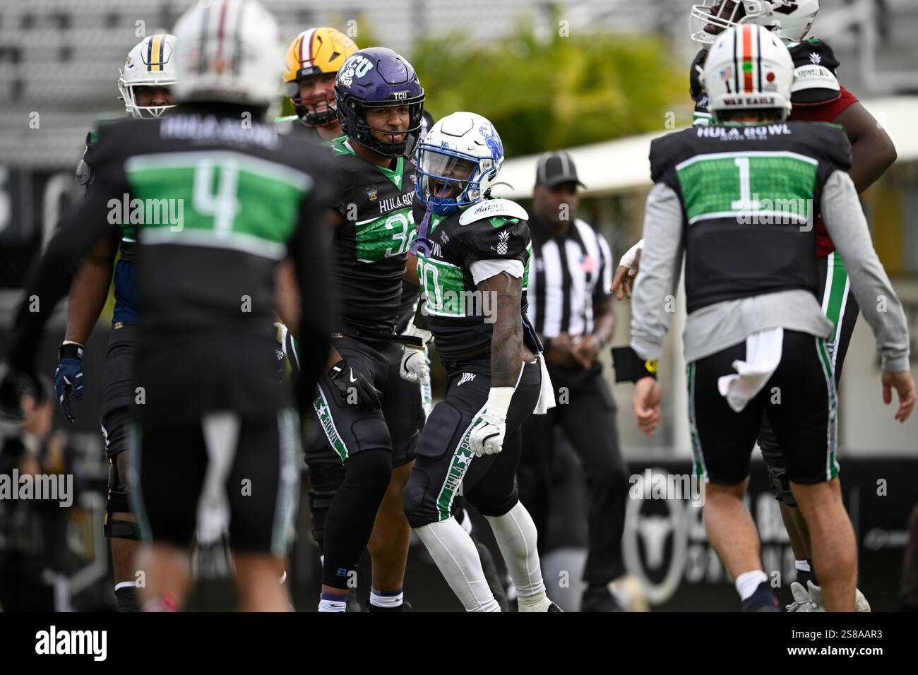 Team Aina running back Mario Anderson (20), of Memphis, celebrates his ...