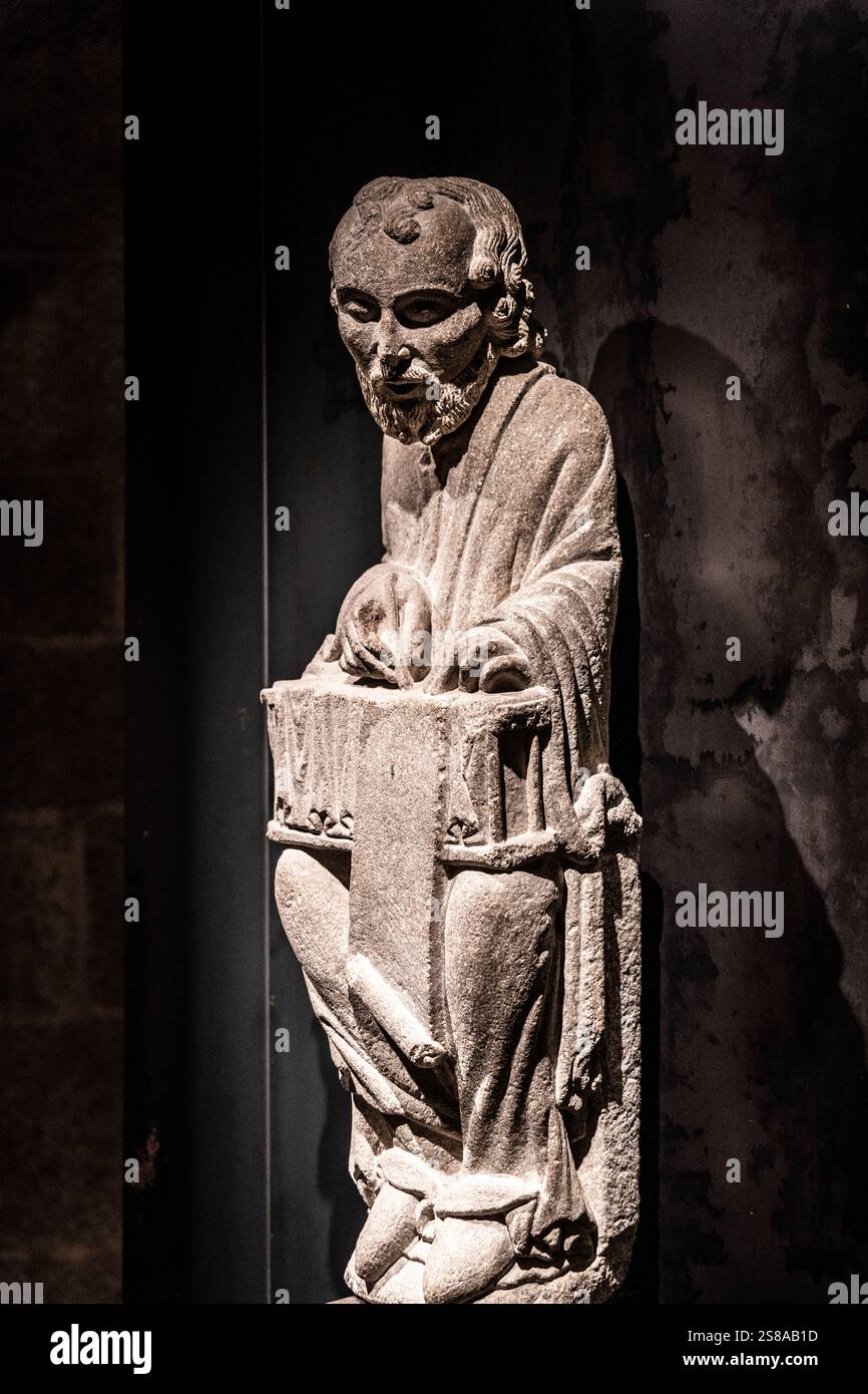 Saint Matthew the Evangelist writing with a pen, 12th century, granite ...