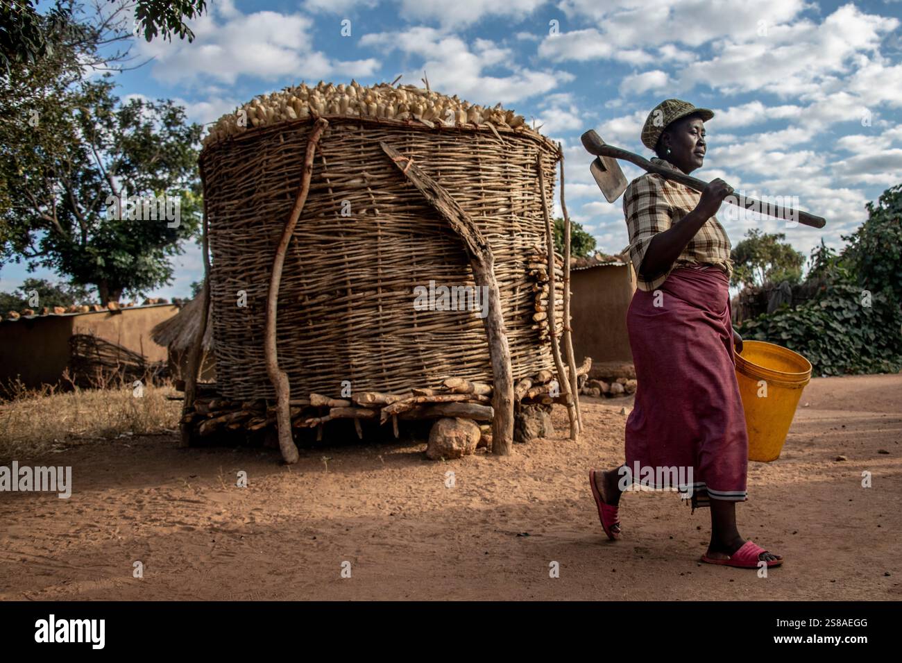 Editorial use only Woman carrying tools to her garden. Photographed in ...