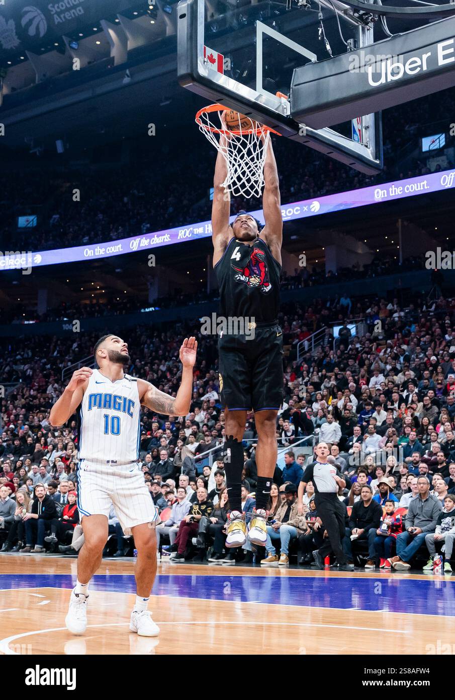 Toronto Raptors forward Scottie Barnes (4) dunks as Orlando Magic guard ...