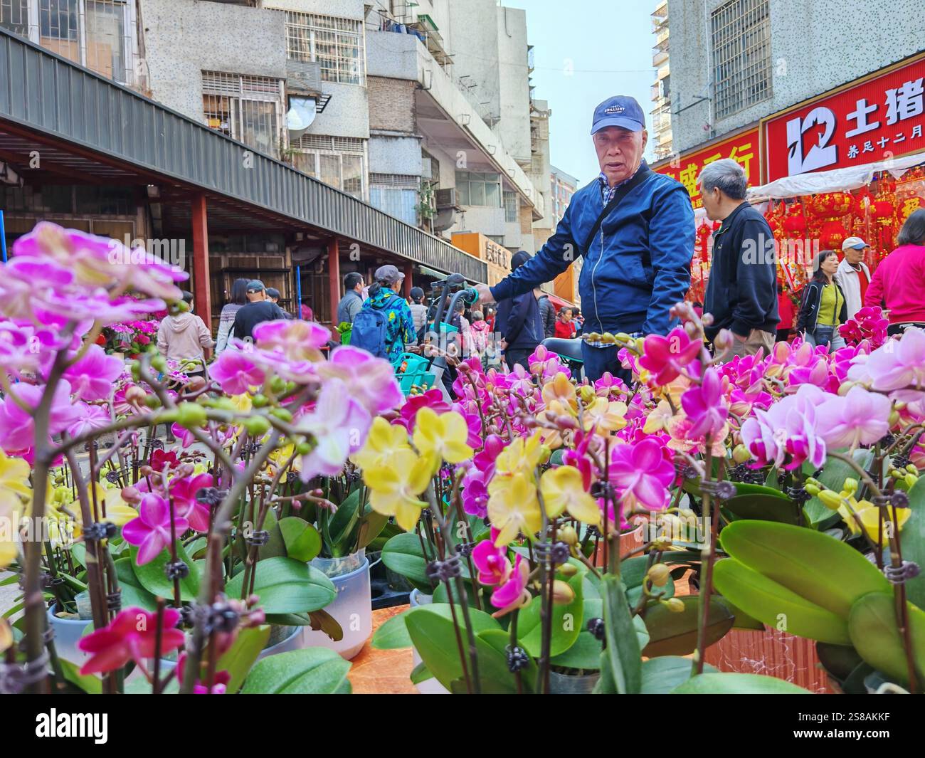 People buy flowers at a flower market in Guangzhou City, south China's ...