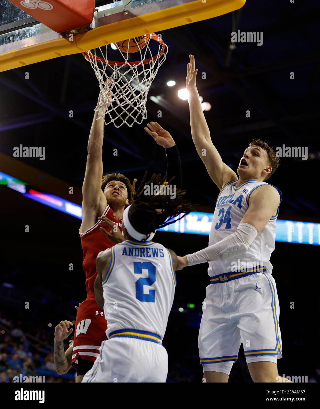 Wisconsin forward Carter Gilmore, left, scores a basket against UCLA ...