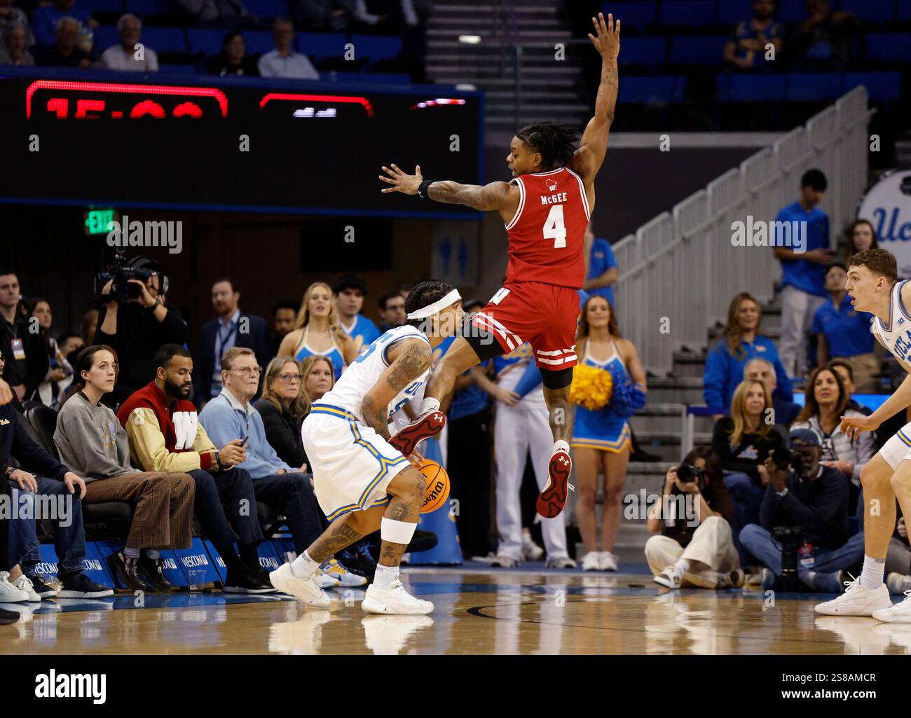 Wisconsin guard Kamari McGee (4) defends against UCLA guard Skyy Clark ...