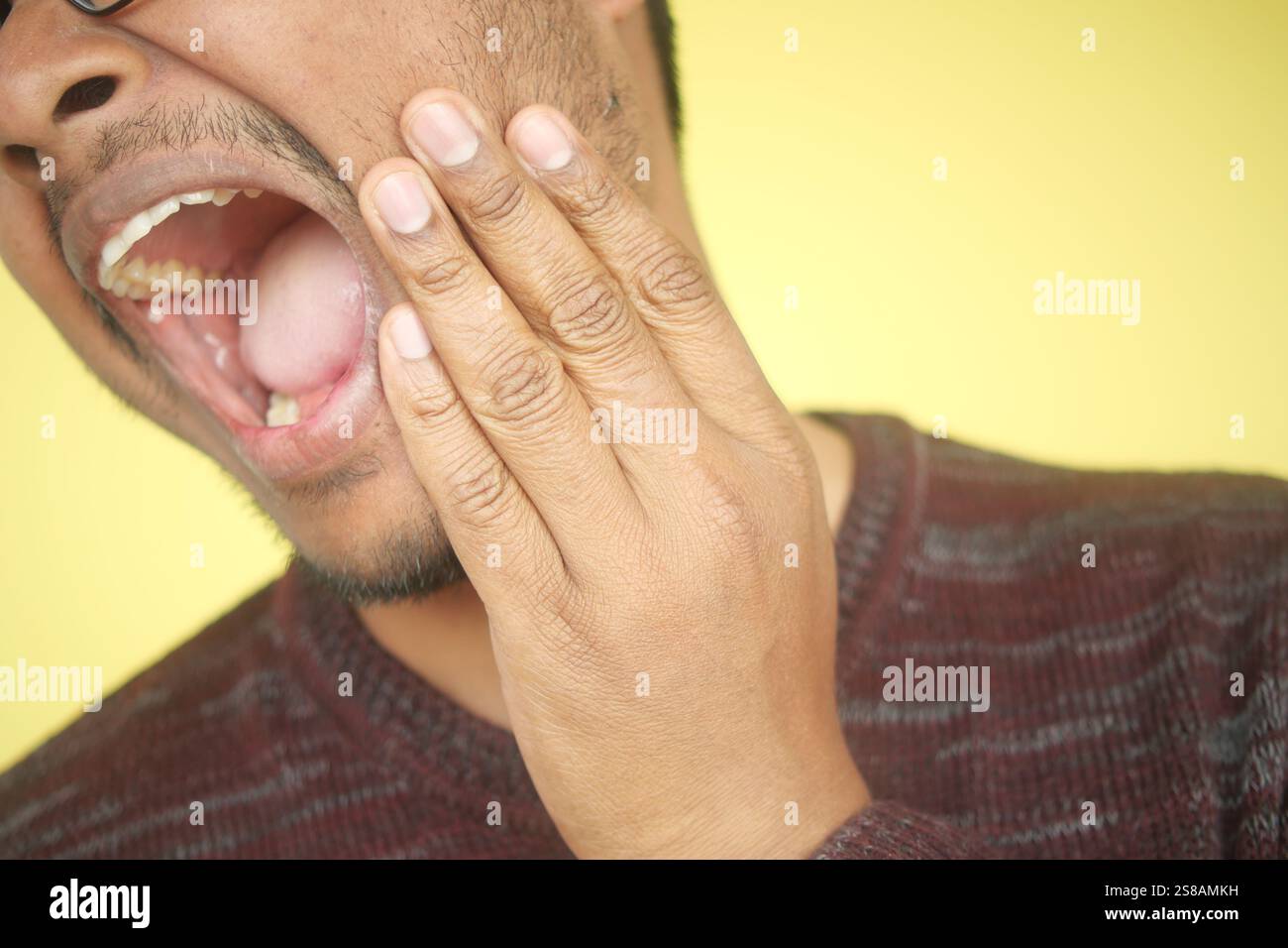 A Person Who is Expressing Pain While Holding Their Face in Distress ...