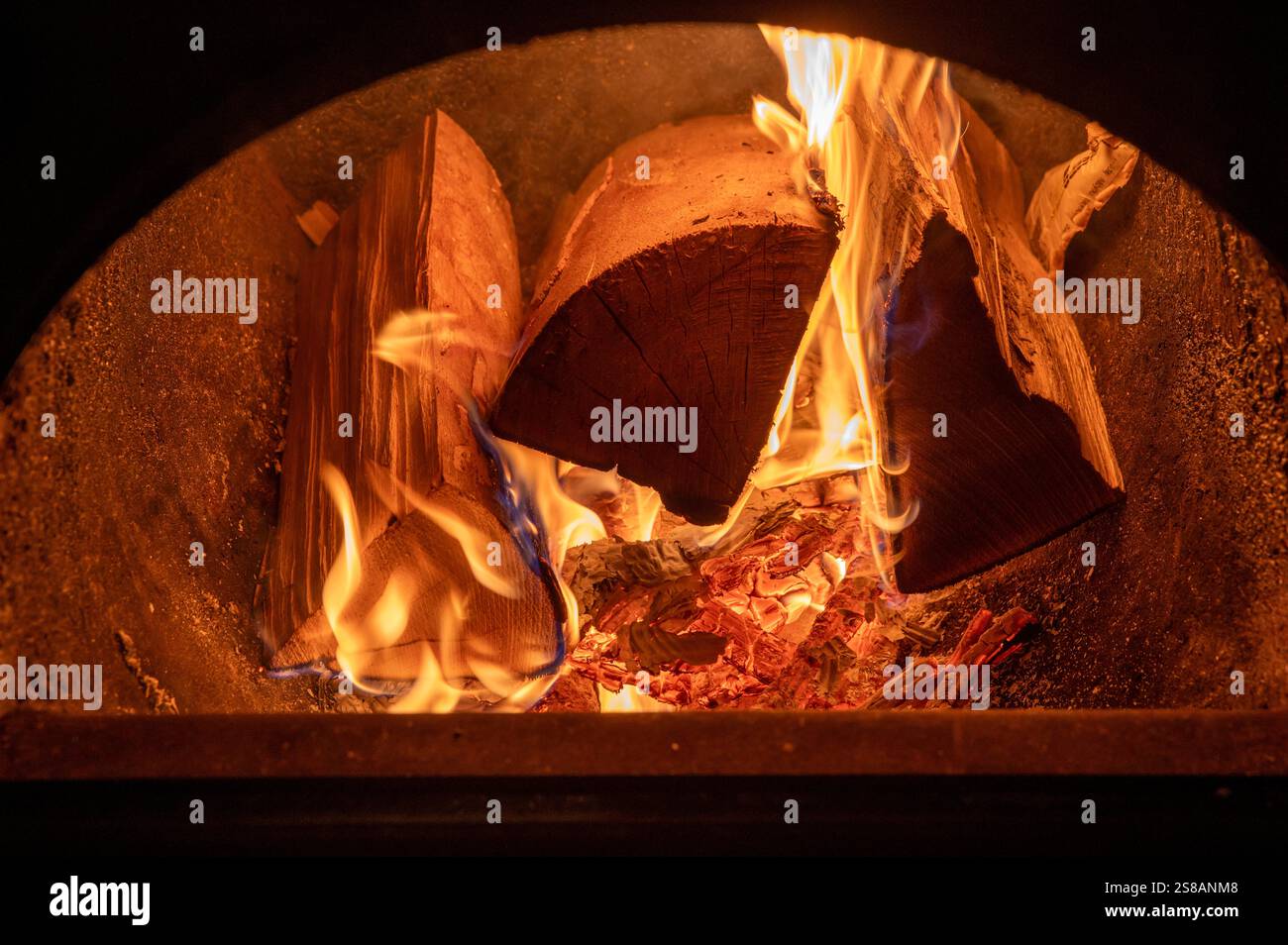 Beech wood burning inside the wood fuel boiler. Alternative fuel, eco ...