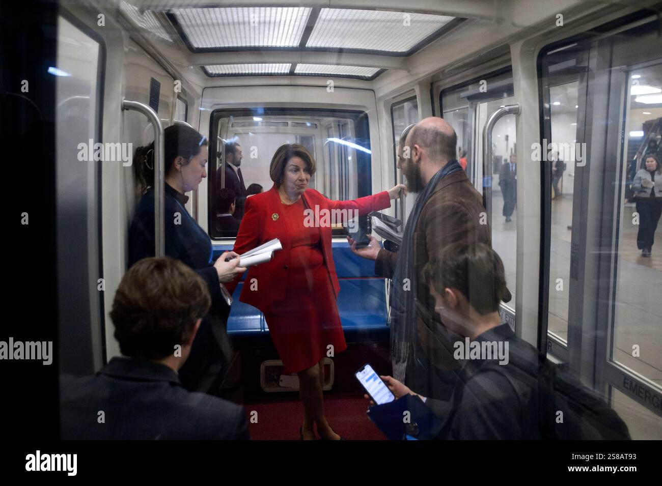 Sen. Amy Klobuchar, D-Minn., talk with reporters while she rides the ...