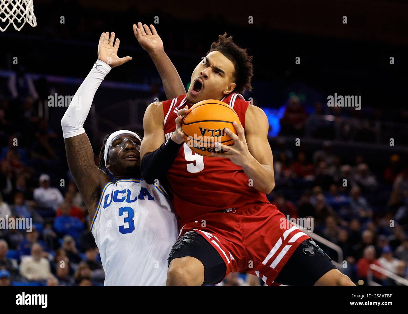 Wisconsin guard John Tonje is fouled by UCLA Eric Dailey Jr. during the ...