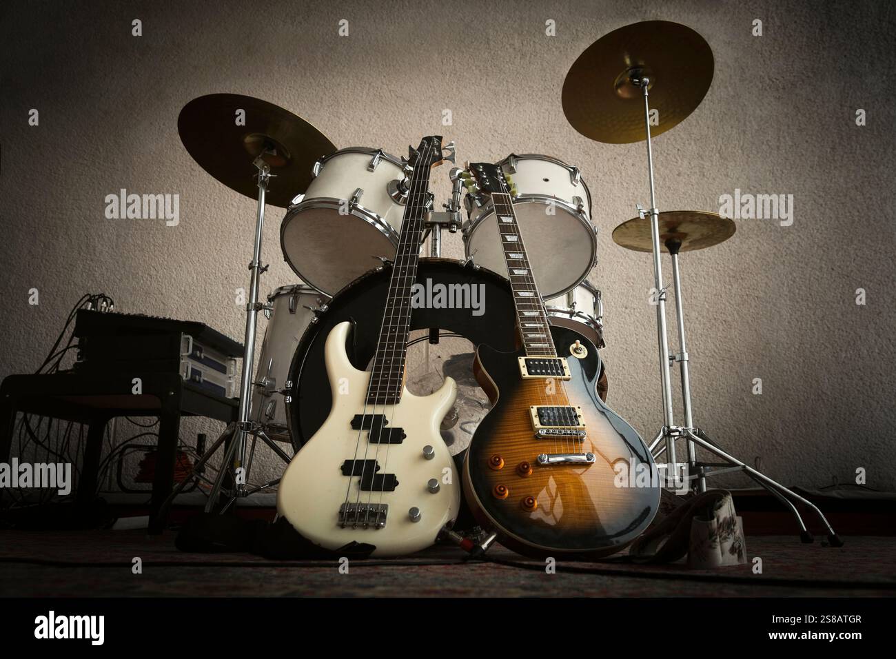 Rock Band, solo guitar, bass, drums in the dark light ready for the gig ...