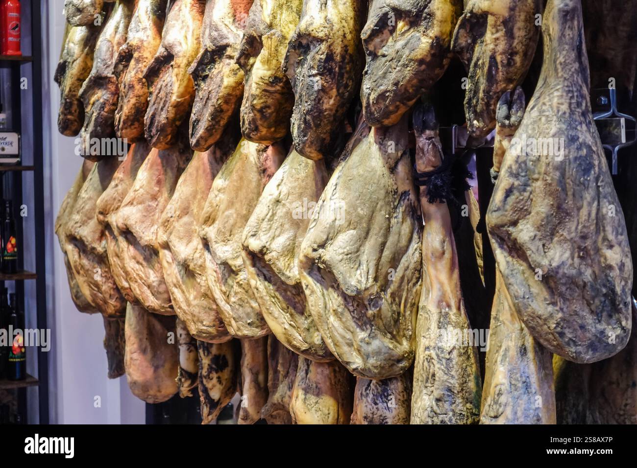 Jamon hanging inside a shop in Toledo, Spain, showcasing traditional ...