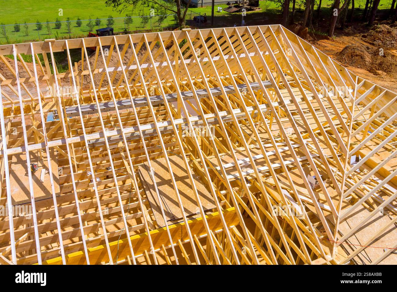 Wooden beams are being assembled to create roof structure at ...