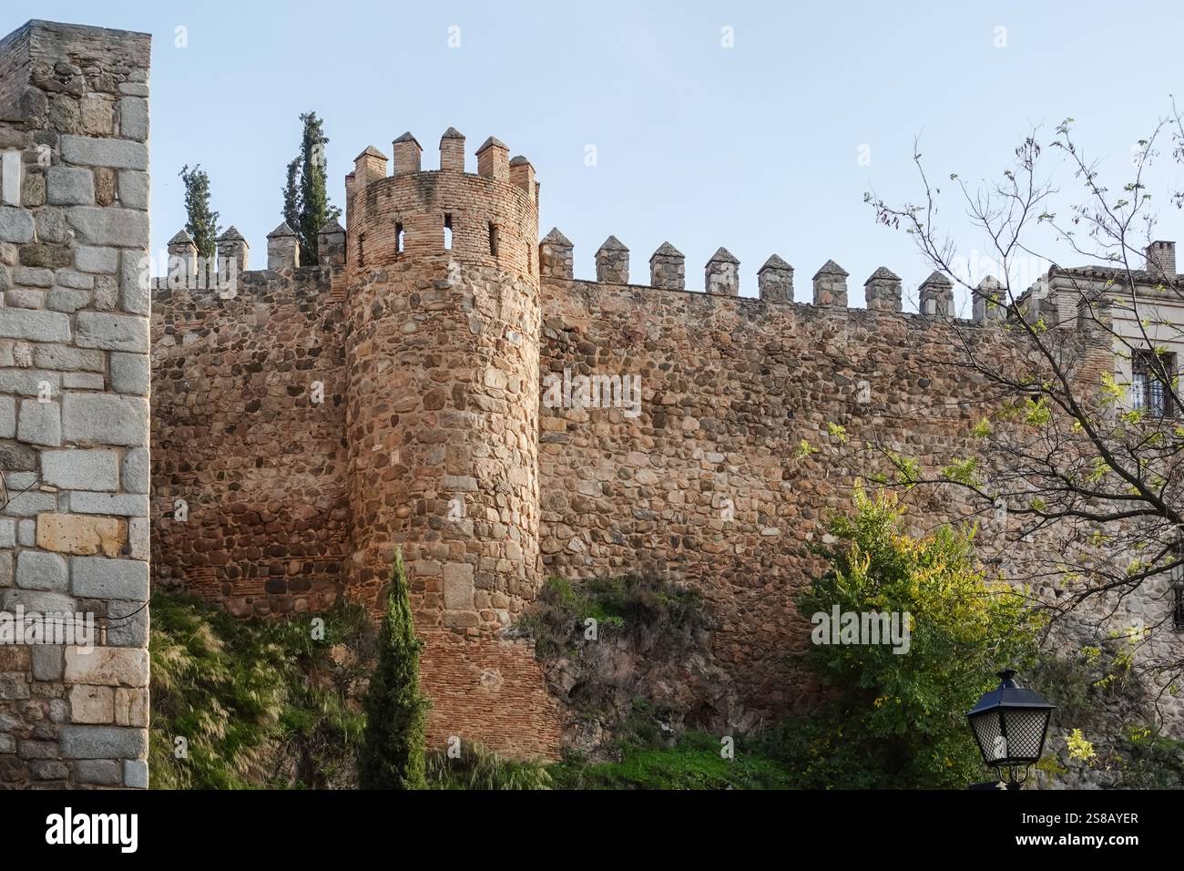Description: Stone fortification with crenellations and towers, part of ...