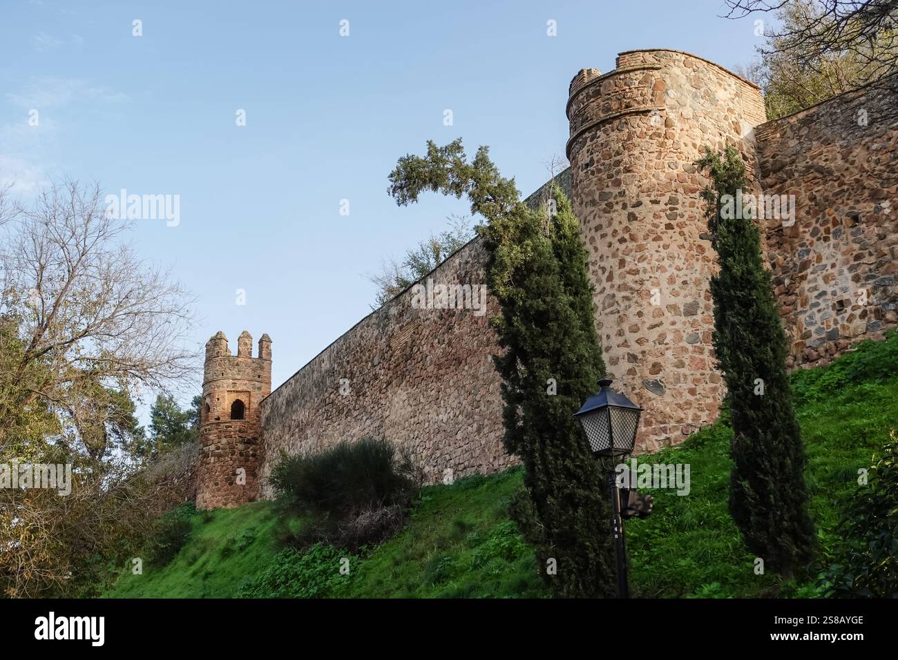 Description: Stone fortification with crenellations and towers, part of ...