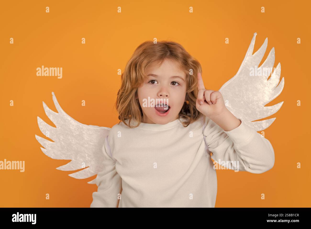 Child angel pointing up, point gesture, idea. Christmas kids. Little ...