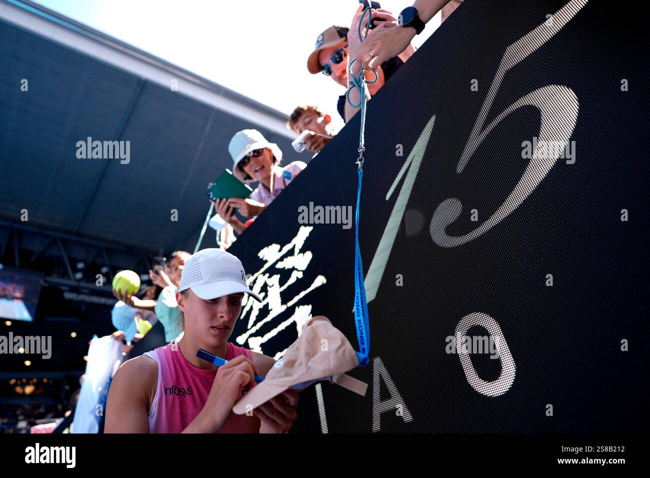 Iga Swiatek of Poland signs autographs after winning her quarterfinal ...