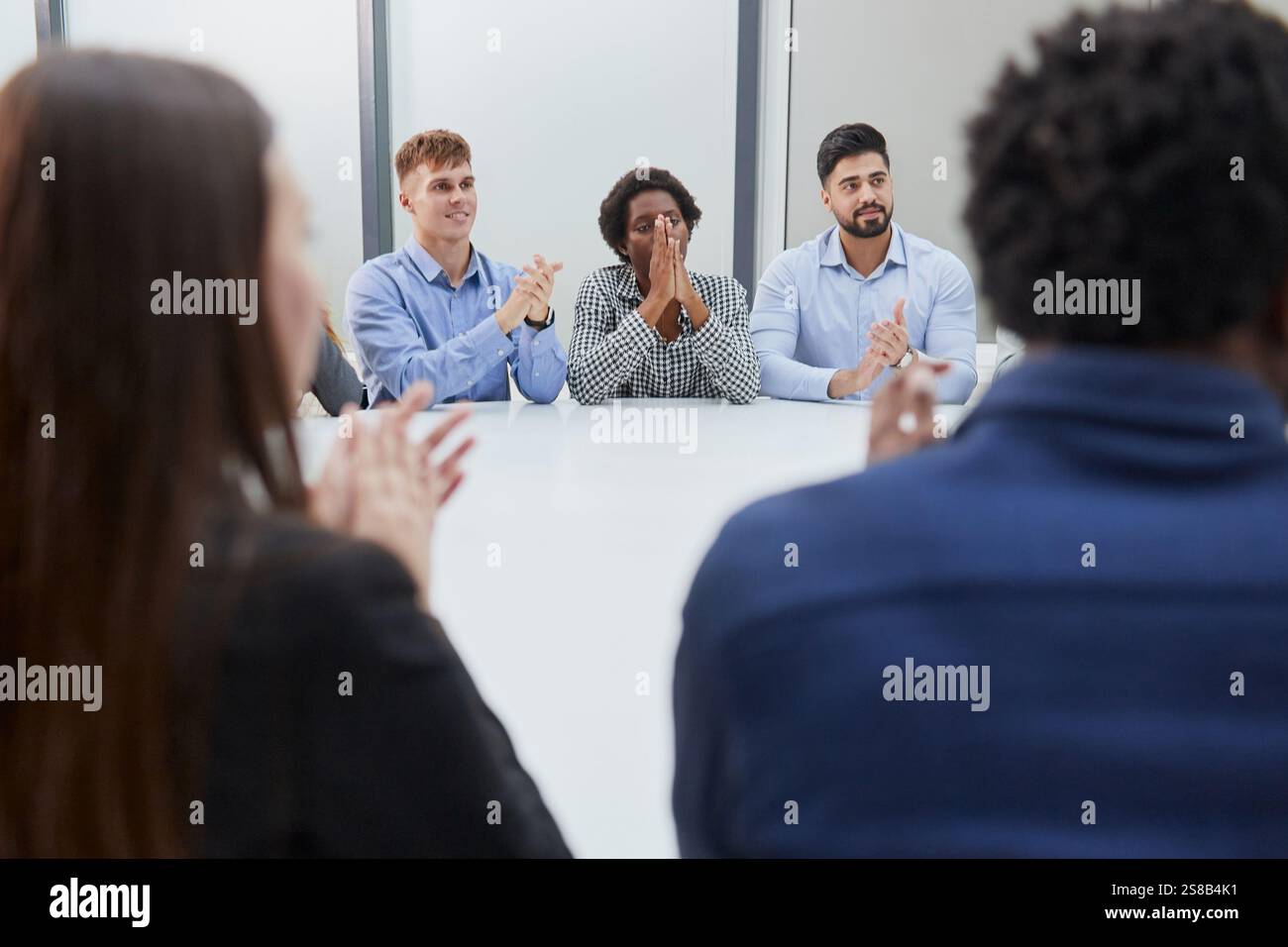 Multicultural businesspeople discussing work sitting at a round table ...
