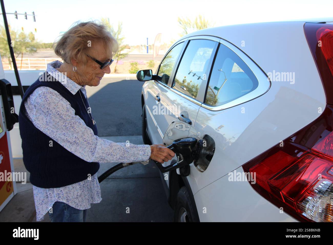 Senior Woman Pumping Her Own Gasoline Stock Photo - Alamy