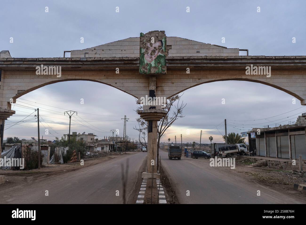 A defaced portrait of former Syrian president Hafez Al-Assad in the ...