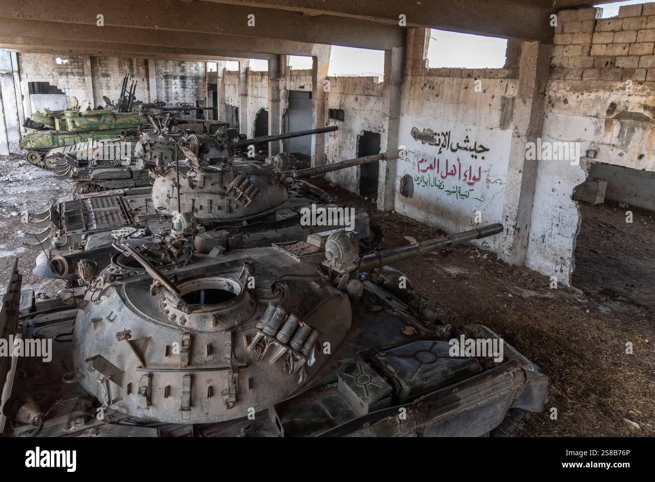 Tanks that belonged to the Assad government sit parked in a warehouse ...