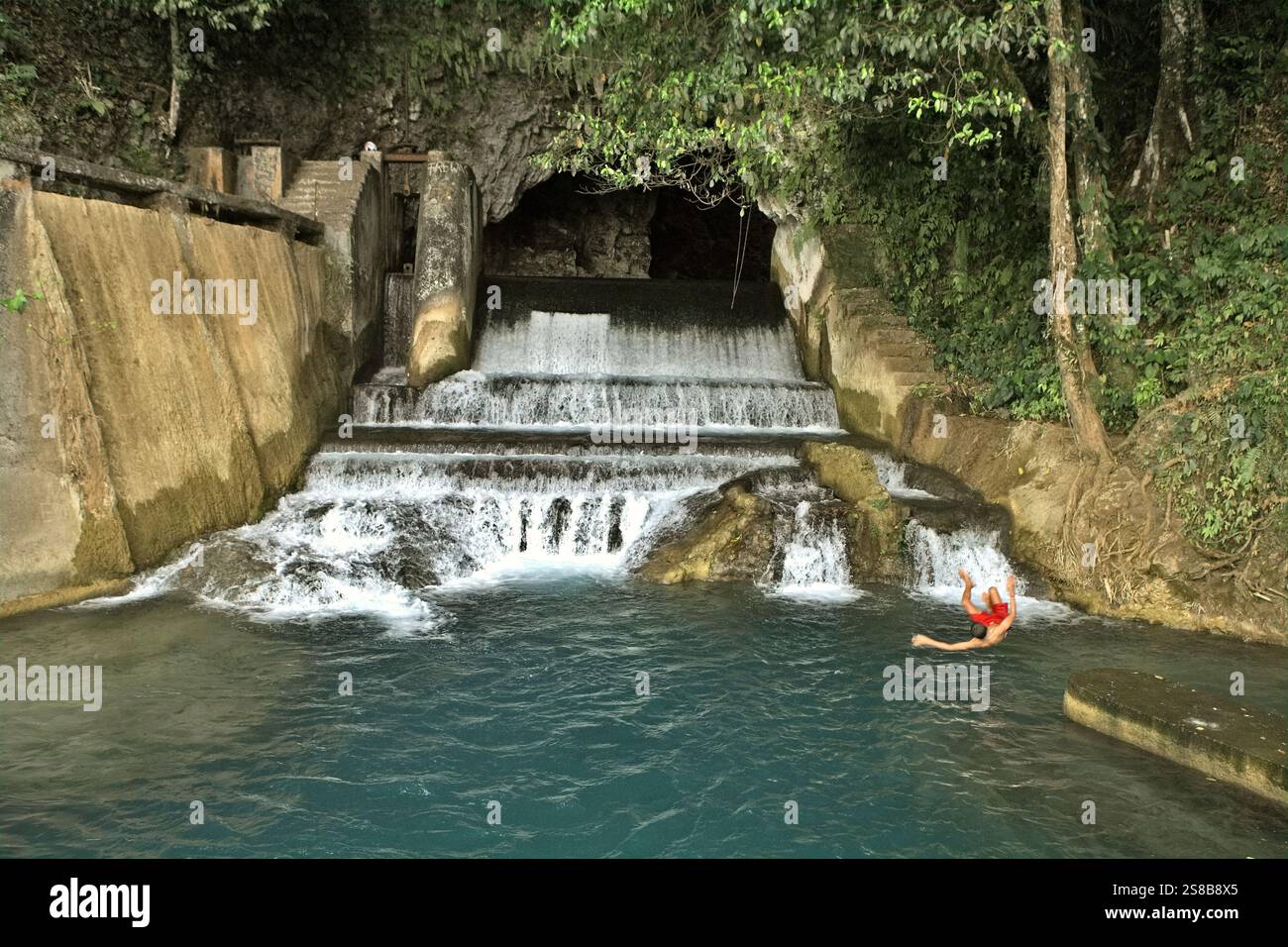 A waterfall and dam at limestone caves of Waikelo Sawah, a rare water ...