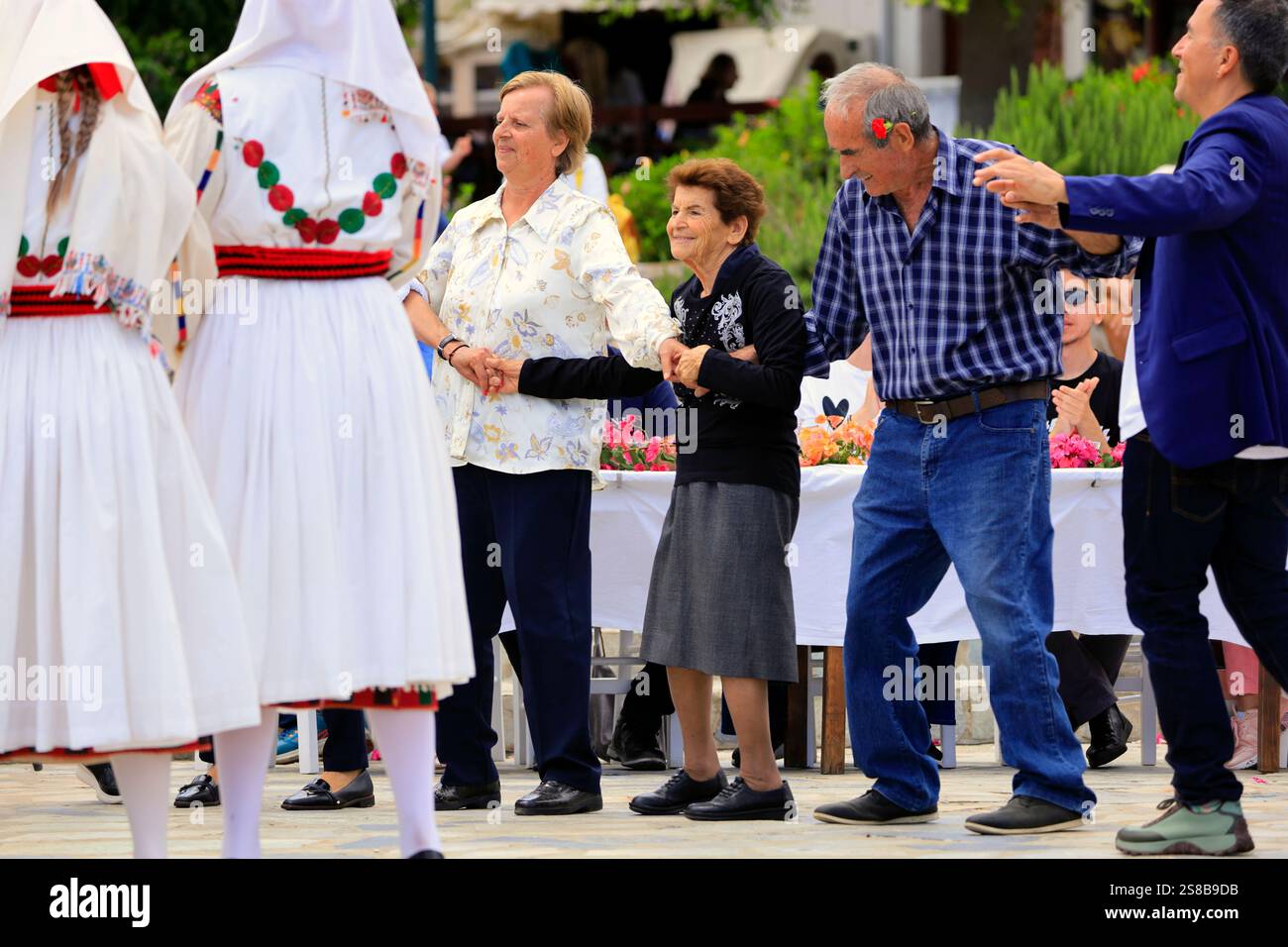 Locals joining in with traditional Greek dancers during the recording ...