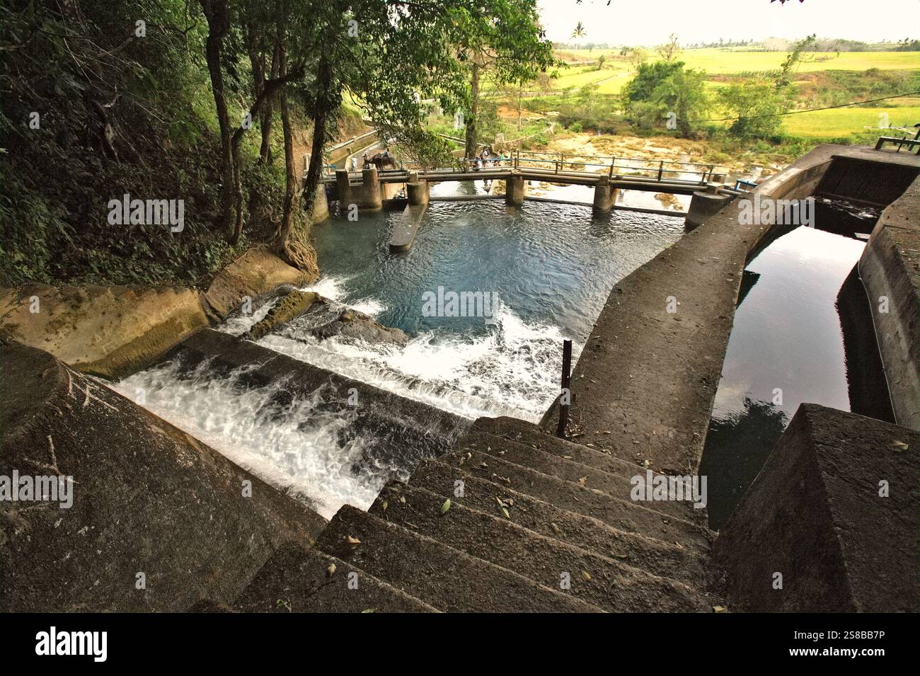 A waterfall and dam at limestone caves of Waikelo Sawah, a rare water ...