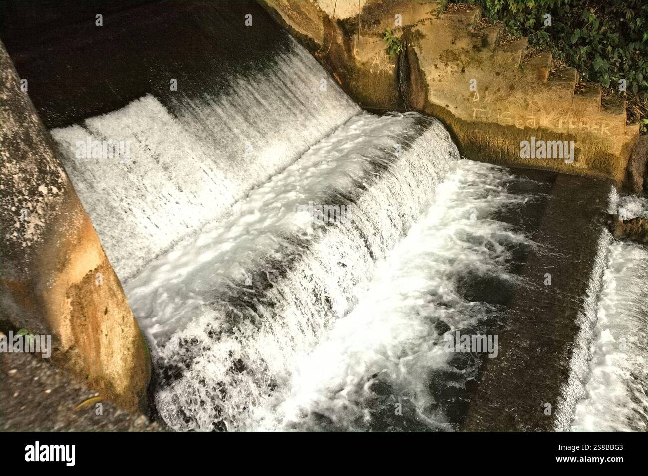 A waterfall and dam at limestone caves of Waikelo Sawah, a rare water ...