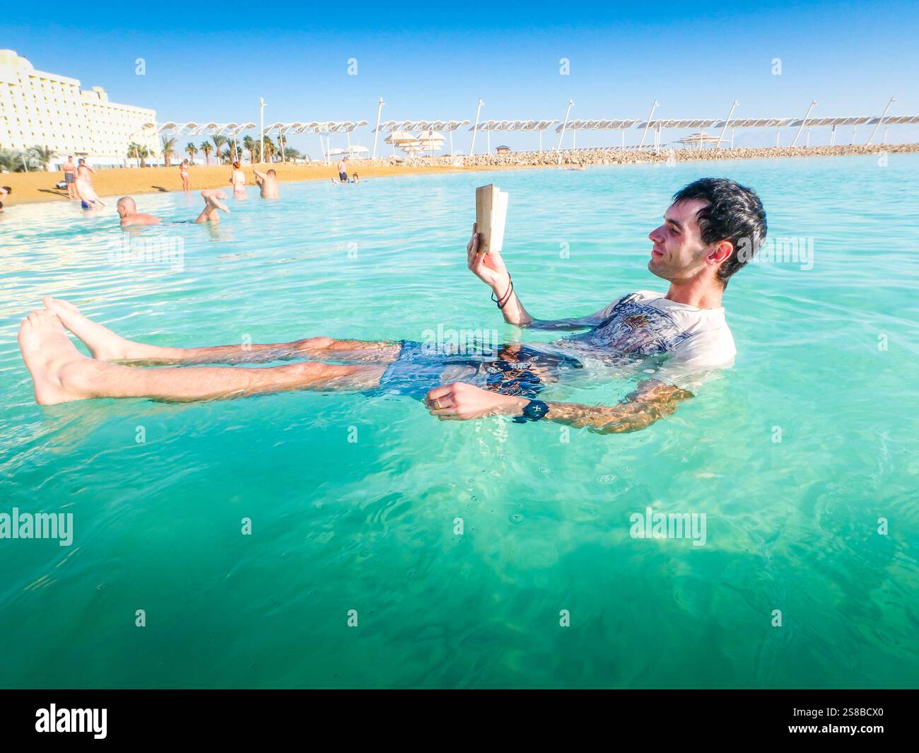 A man reading a book while floating in the Dead Sea in Israel Stock ...