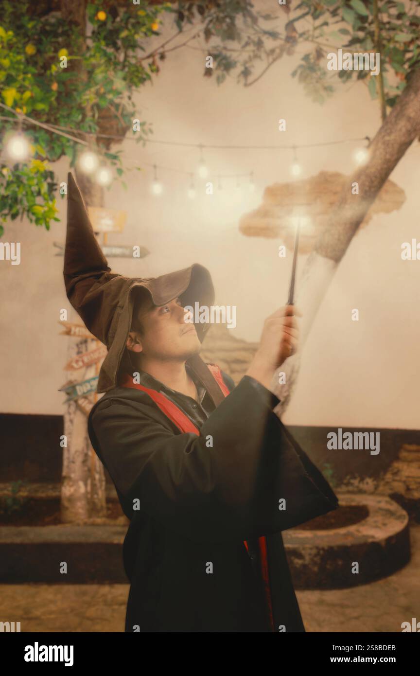 Man dressed in wizard attire performing magic in a whimsical garden at ...