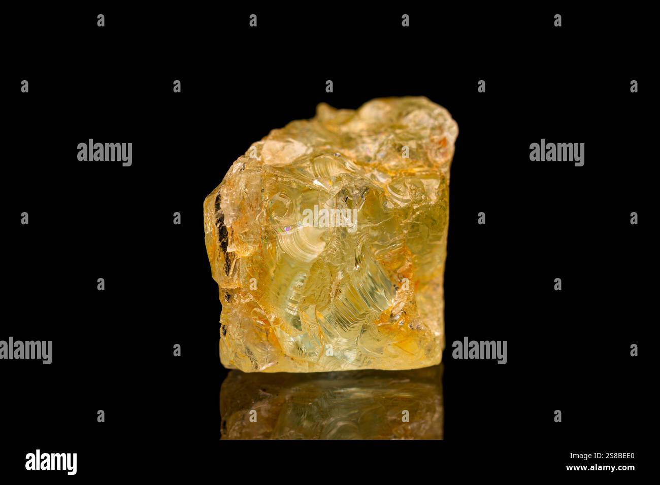 Natural rough golden beryl (beryl group) gemstone on dark background ...