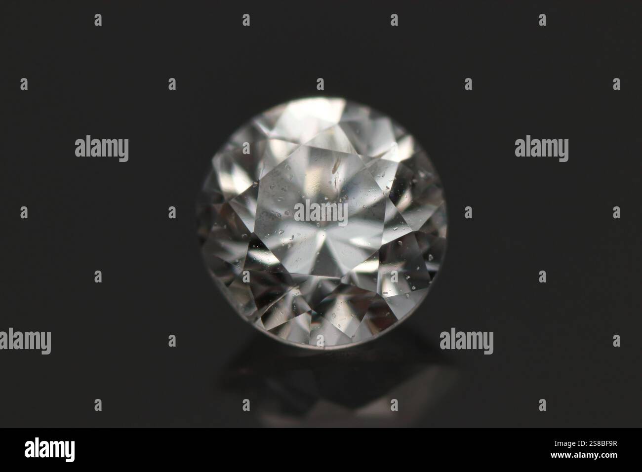 Closeup facet cut natural diamond at 5X magnification show an ...