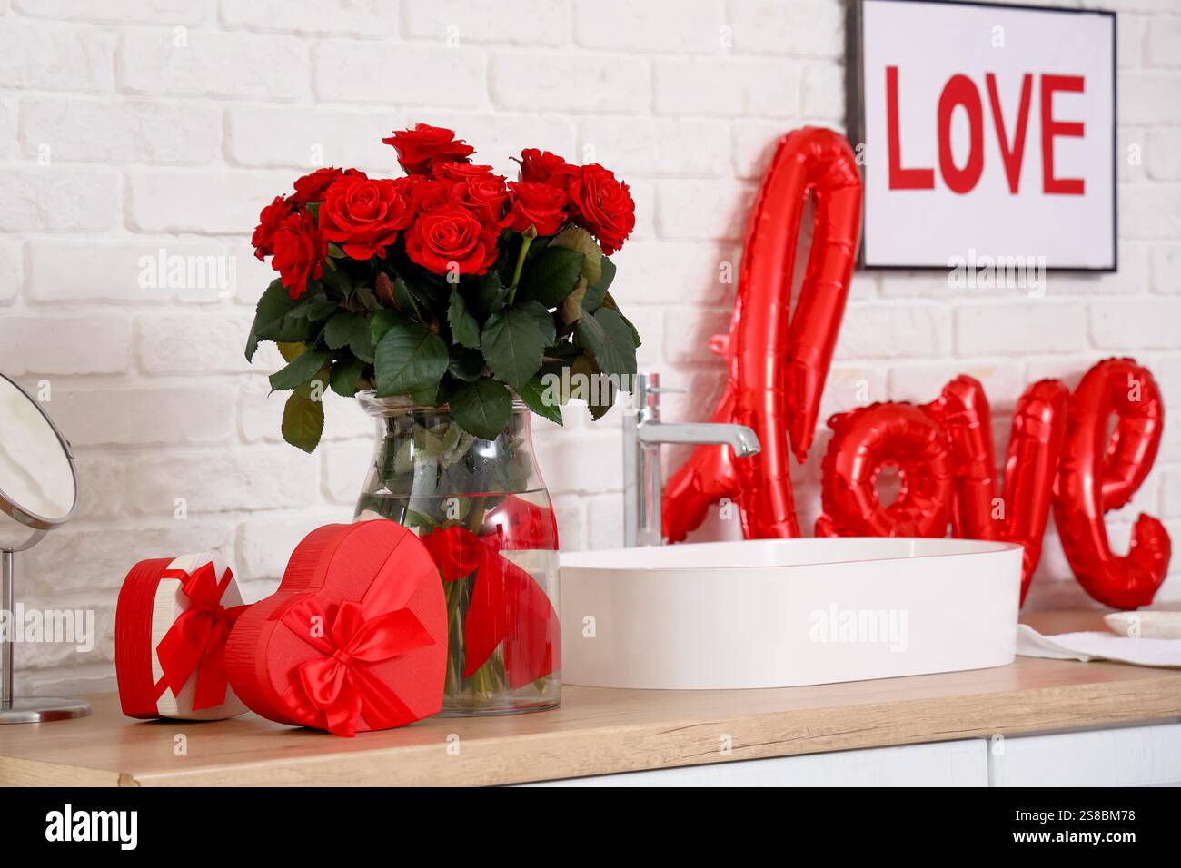 Wooden counter with sink, bouquet of red roses and word LOVE made from ...